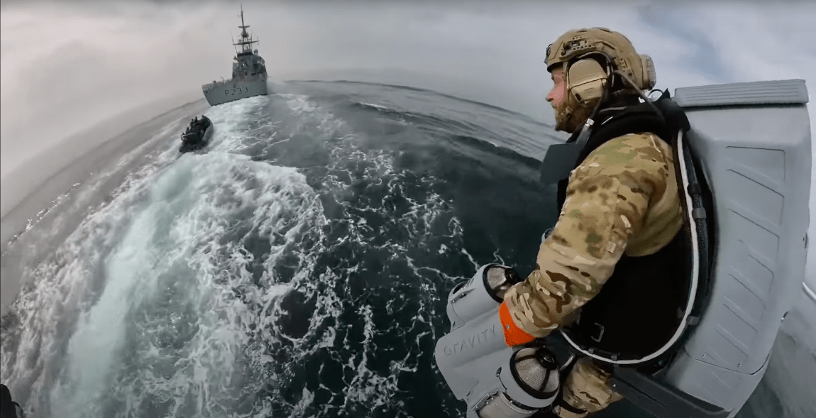 Watch a Royal Marine use a jet pack to fly over and board an enemy ship