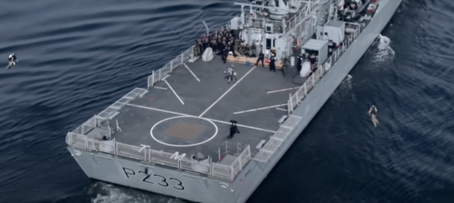 Watch a Royal Marine use a jet pack to fly over and board an enemy ship