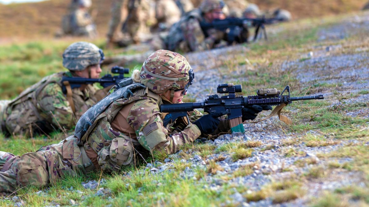 Pregnant Army National Guardsman sits in armory during annual training