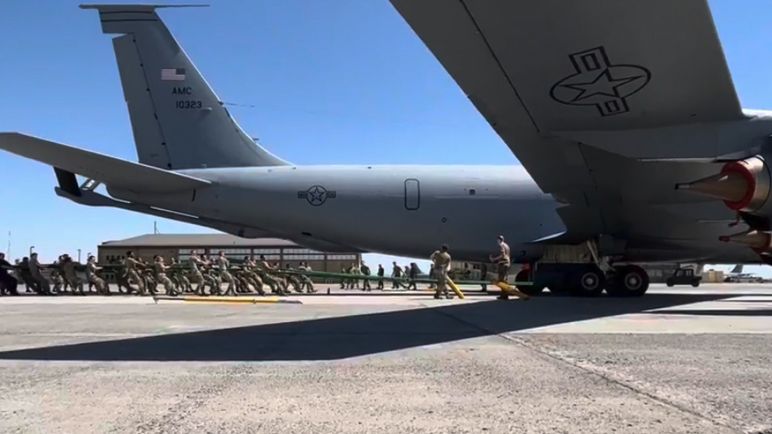 Air Force members play tug of war with a 49-ton plane