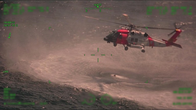 Watch a Coast Guard rescue crew lift boaters out of shark-infested waters