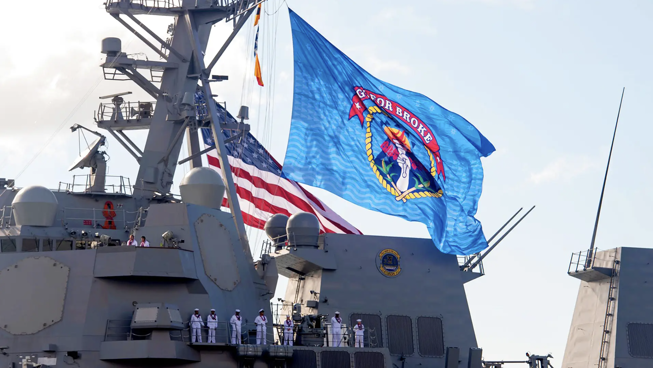 Navy destroyer USS Daniel Inouye flies 'Go For Broke' battle flag in port