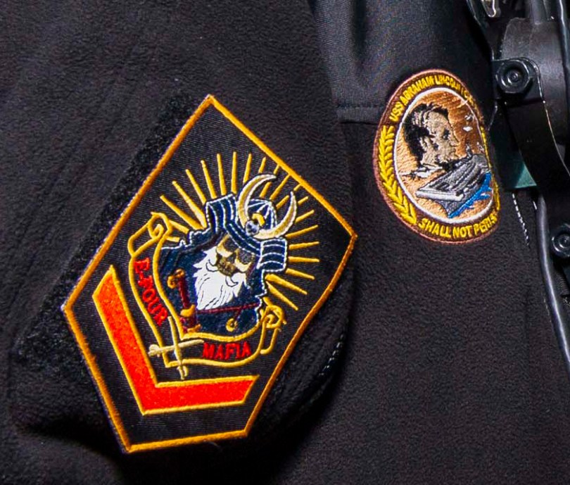 This USS Abraham Lincoln sailor proudly wears 'E-4 Mafia' patch