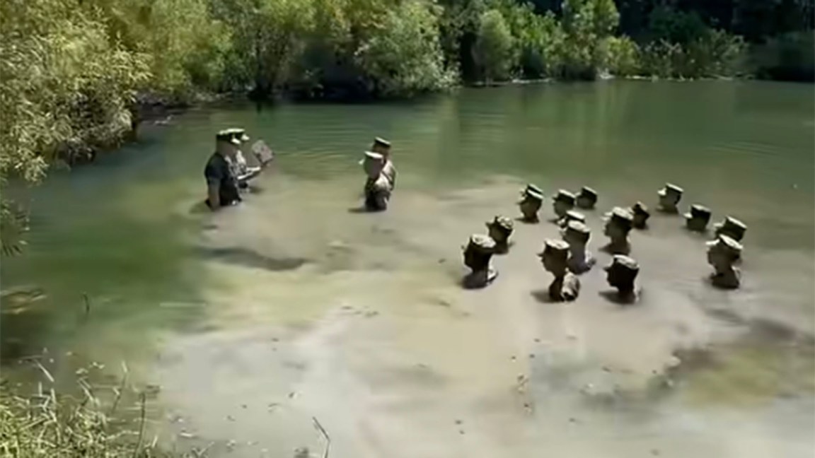 Marines reenlist in a disgusting pool of muck